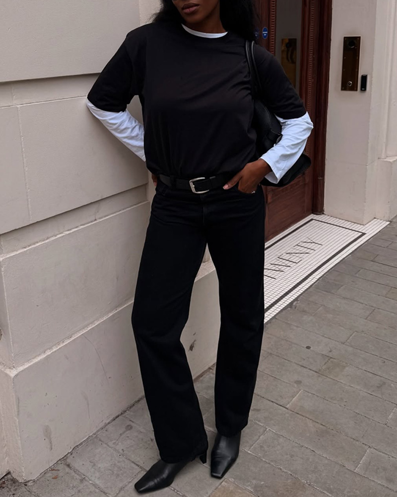 Street style outfit featuring black high-waisted jeans%2C layered long-sleeve tee%2C leather ankle boots%2C styled on a city sidewalk outside a townhouse
