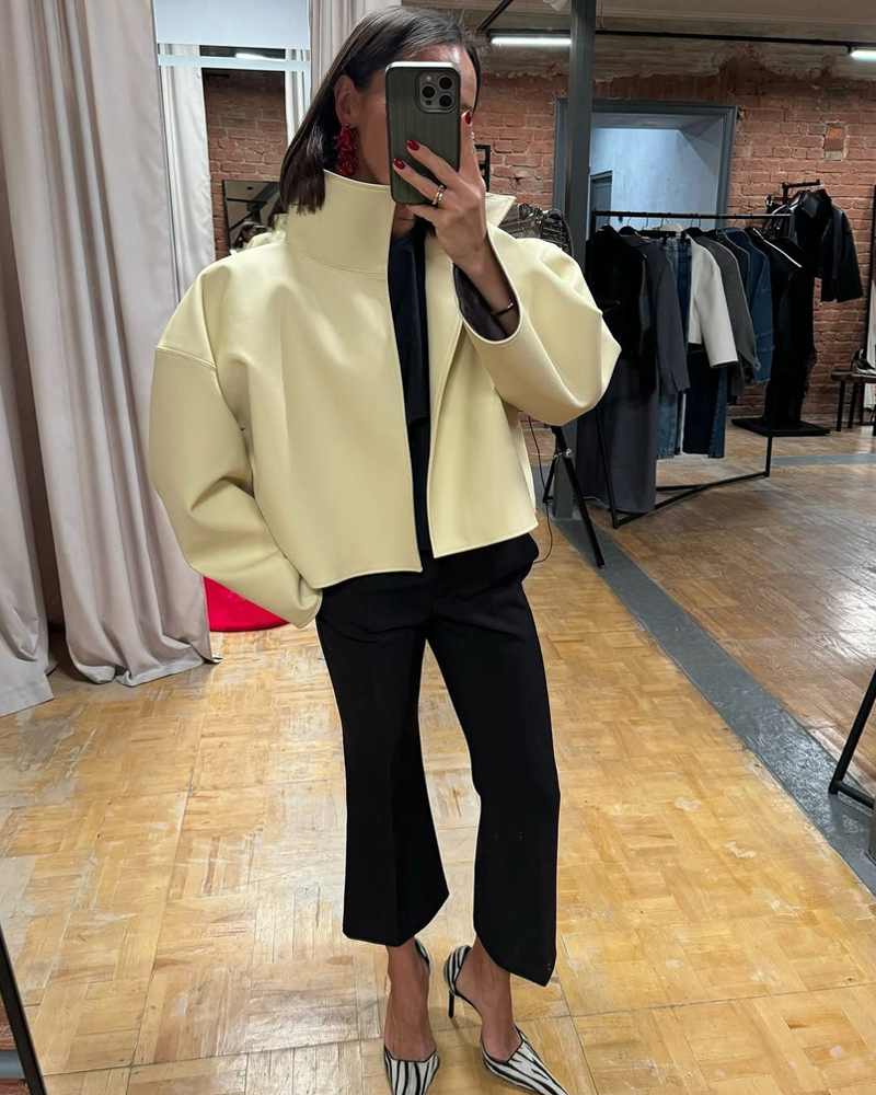 Mirror selfie featuring cream cropped jacket%2C black cropped trousers and pointed heels in a boutique fitting room