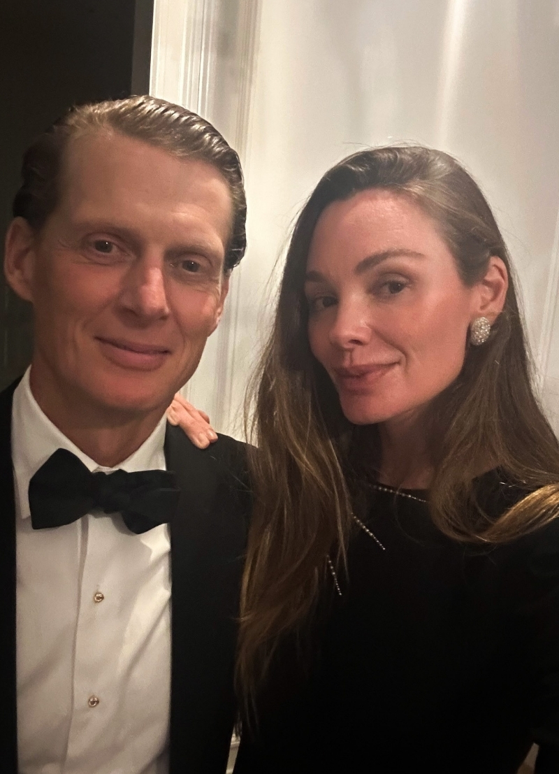 Couple in formal eveningwear with black tuxedo and dress, styled indoors for an elegant night setting