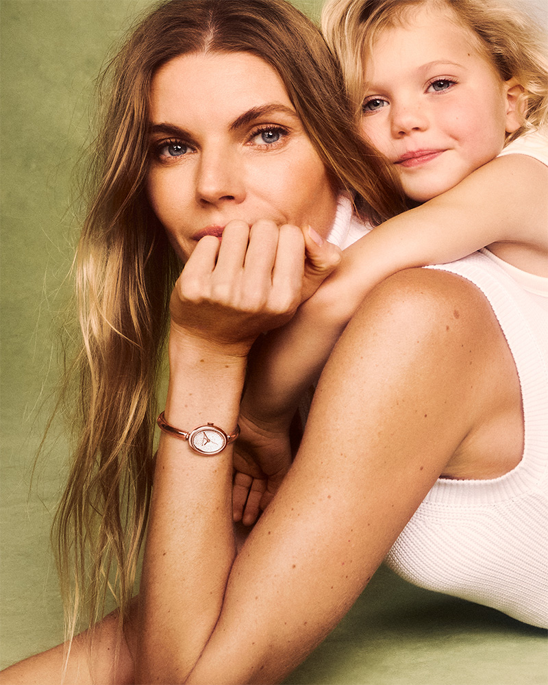 Mother and child portrait featuring a white ribbed tank top and delicate gold watch%2C styled against a soft neutral studio backdrop