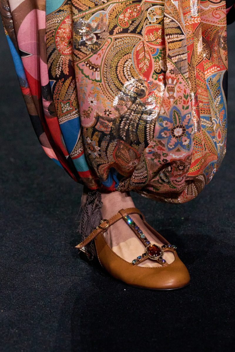 Etro brown leather T-strap flat shoe with jeweled embellishments paired with colorful paisley print silk pants