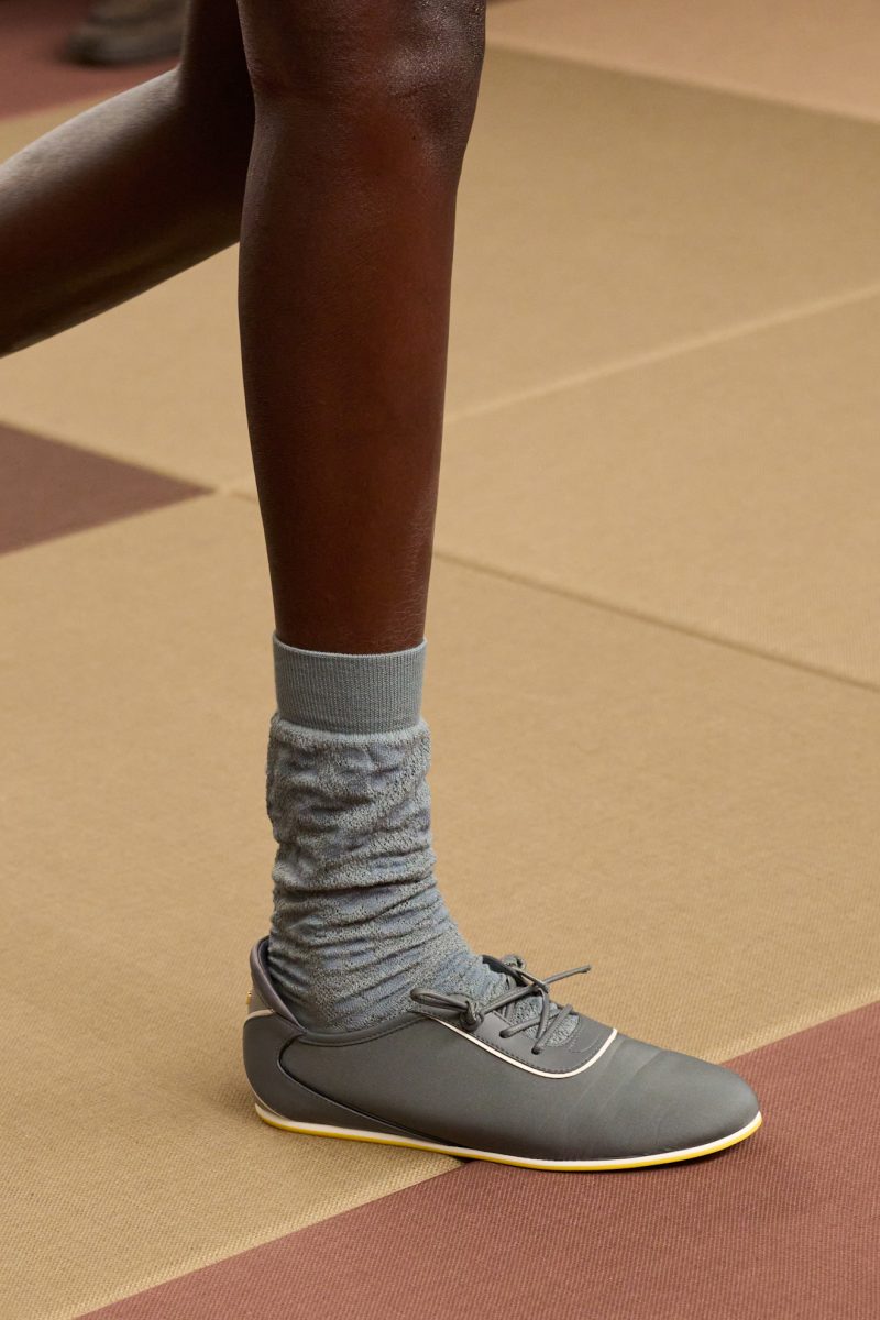 gray leather Fendi lace-up flat shoe paired with slouchy light gray socks on runway model's foot