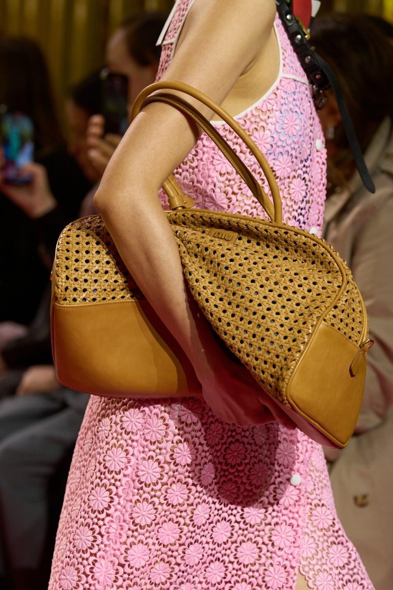 Miu Miu woven leather top handle bag in tan paired with pink floral lace dress, showcasing artisanal texture and spring runway style