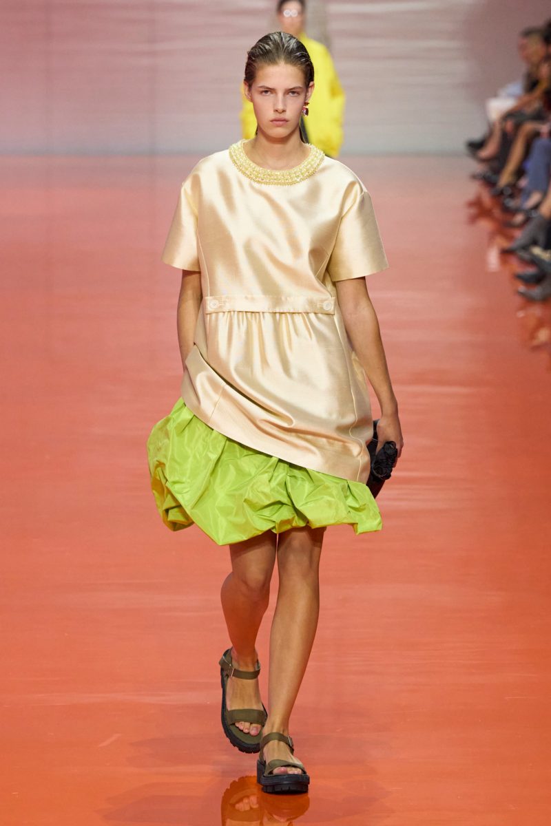 Prada satin short-sleeve dress with pearl-embellished neckline and lime green ruffled hem, styled with chunky sandals on runway