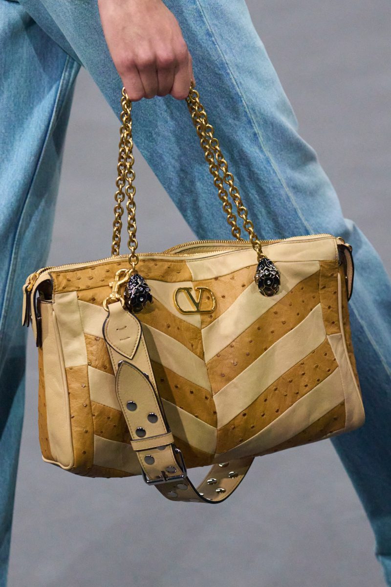 Valentino Garavani VLogo chain shoulder bag in tan and cream chevron leather with gold hardware, styled with light wash denim