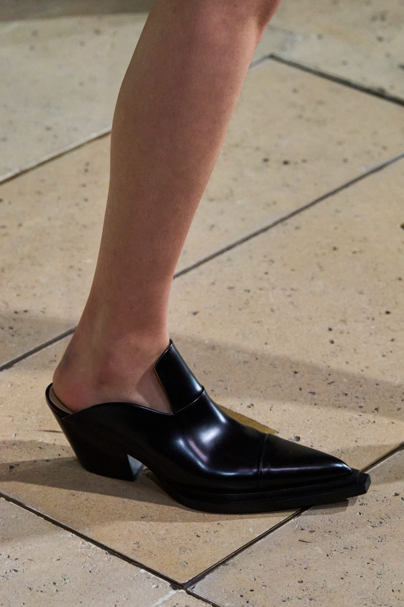 black leather pointed-toe mule with a sculpted block heel and slip-on design for fall fashion
