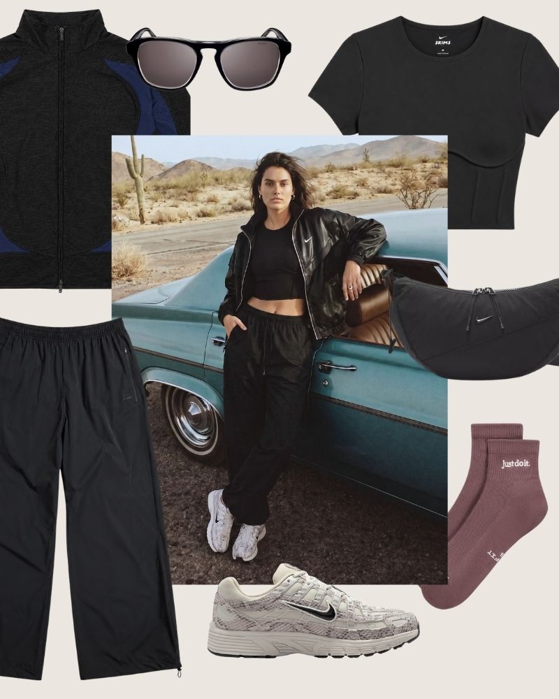 Nike activewear outfit featuring a black windbreaker%2C crop top and track pants with sneakers and accessories in a desert setting