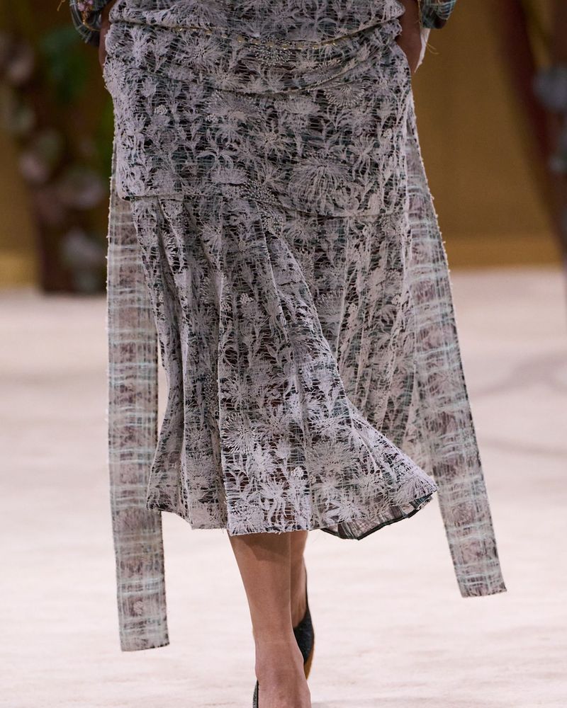 Chanel haute couture layered lace midi skirt in soft gray with intricate floral pattern and black textured heels