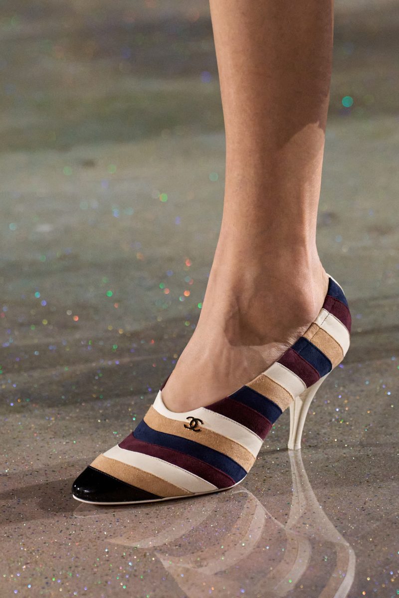 Chanel pointed toe pump with multicolor velvet stripes in navy, burgundy, beige, and white, featuring a black toe cap and gold logo detail