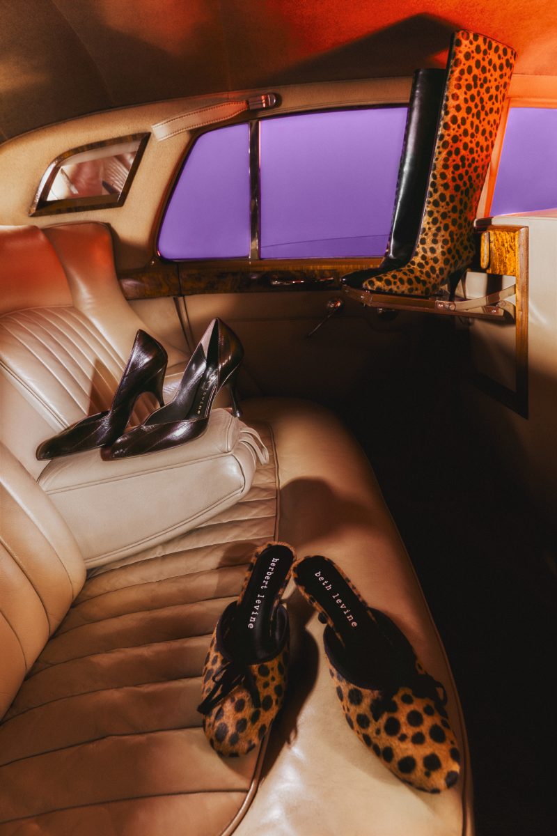 Leopard print knee-high boots and matching slip-on mules by beth levine paired with black leather pointed-toe heels on a vintage car seat
