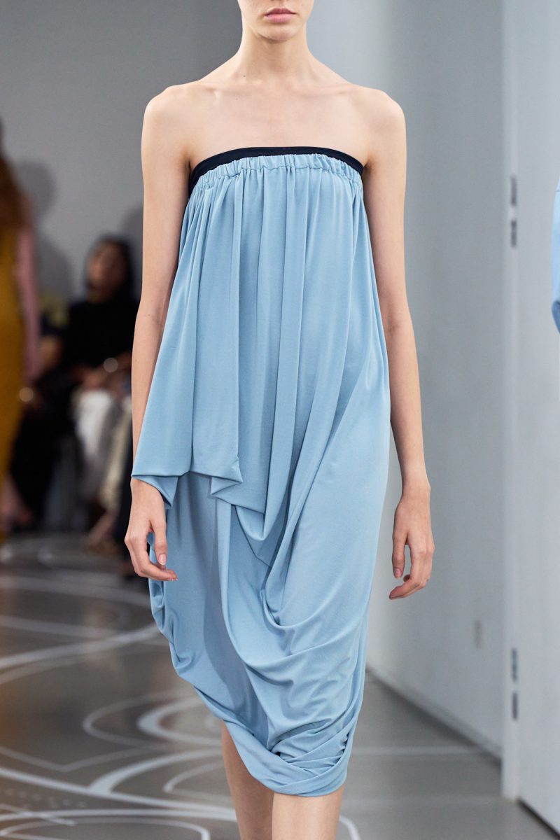 Strapless light blue draped dress with black trim at the neckline, featuring a loose, flowing silhouette perfect for spring summer fashion