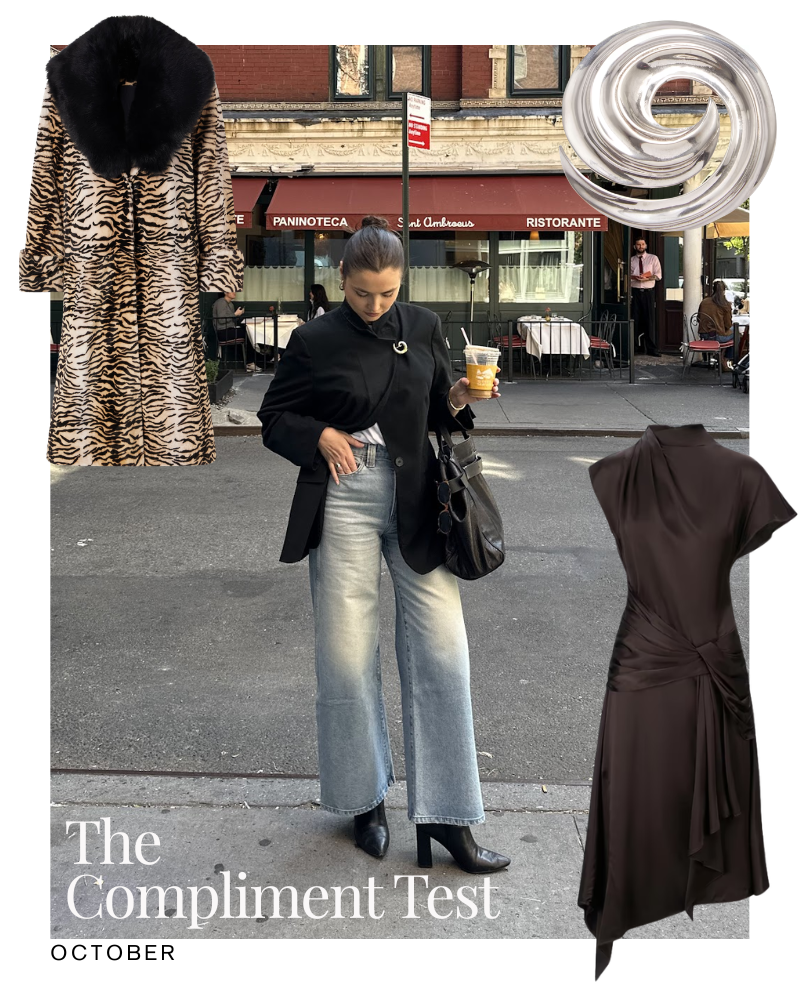Chic autumn ensemble featuring a black statement coat%2C high-waisted denim jeans%2C and sleek ankle boots%2C complemented by a silver swirl ring