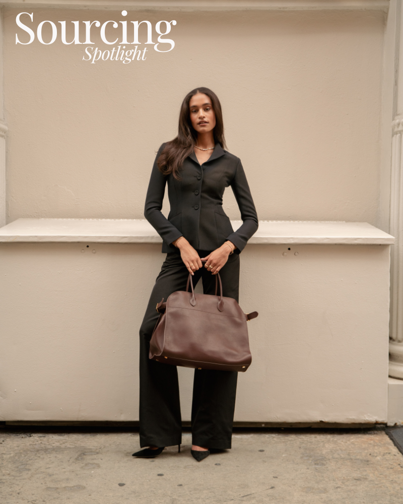 Sophisticated black tailored suit by The Row%2C paired with sleek pointed-toe heels and a rich brown leather tote bag for a polished look